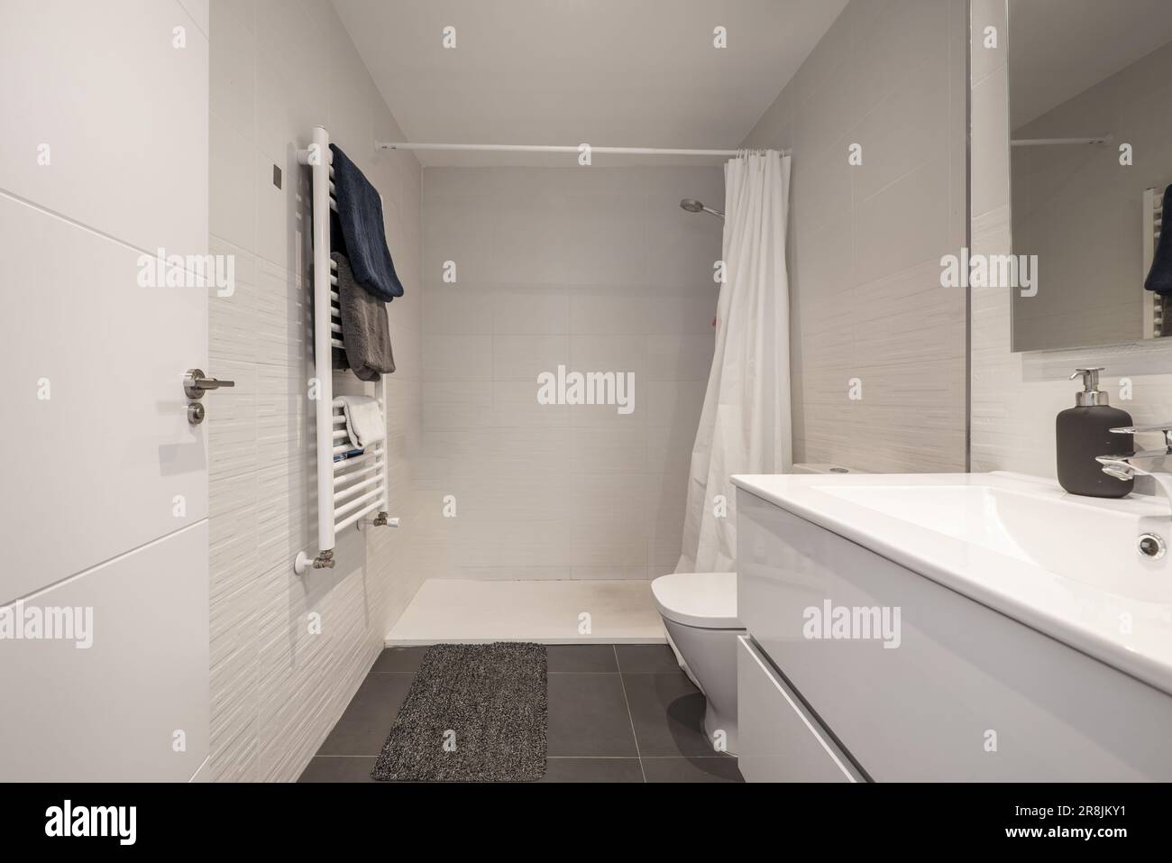 Small simple bathroom with white porcelain sink, white heated towel ...