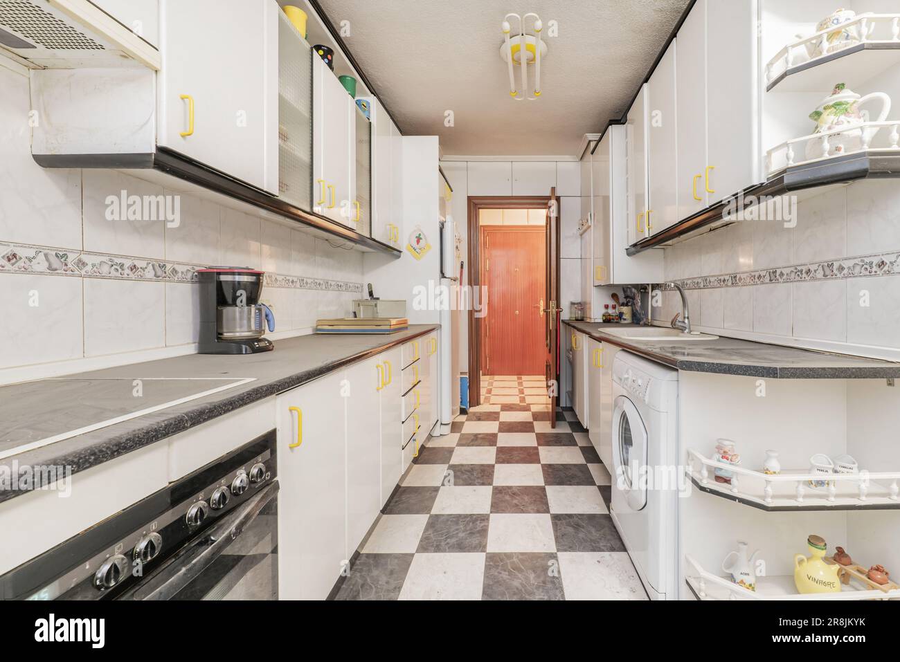 elongated kitchen with cabinets on both sides of the walls, granite ...