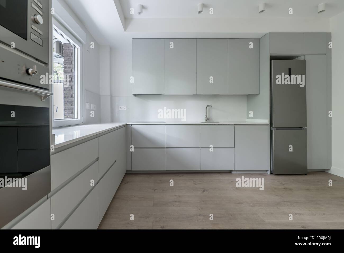 Newly installed modern kitchen covering two walls in an L shape with ...