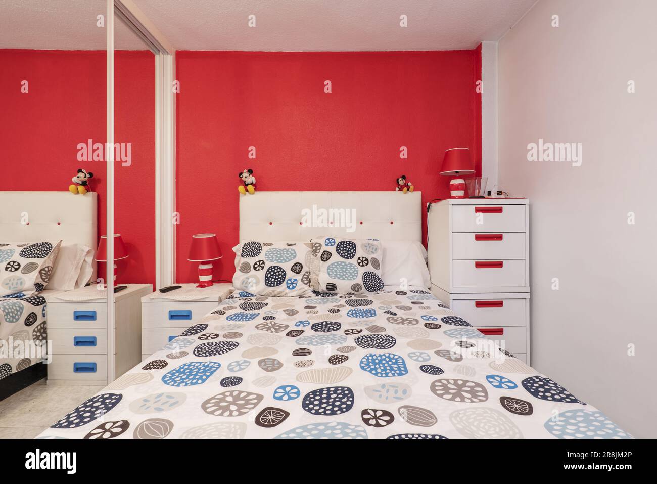 Frontal image of a bedroom with a double bed with an upholstered ...