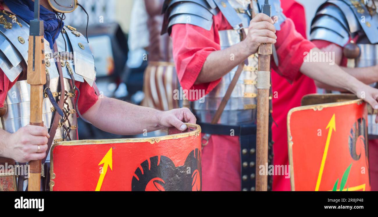 Reenactors as roman legionaries in formation. Hands holding pila and ...