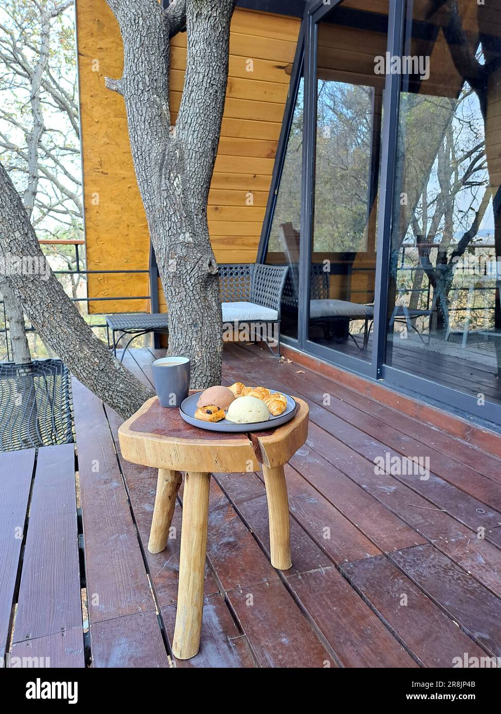 Breakfast on the terrace of a cabin in the woods on a wooden table with ...