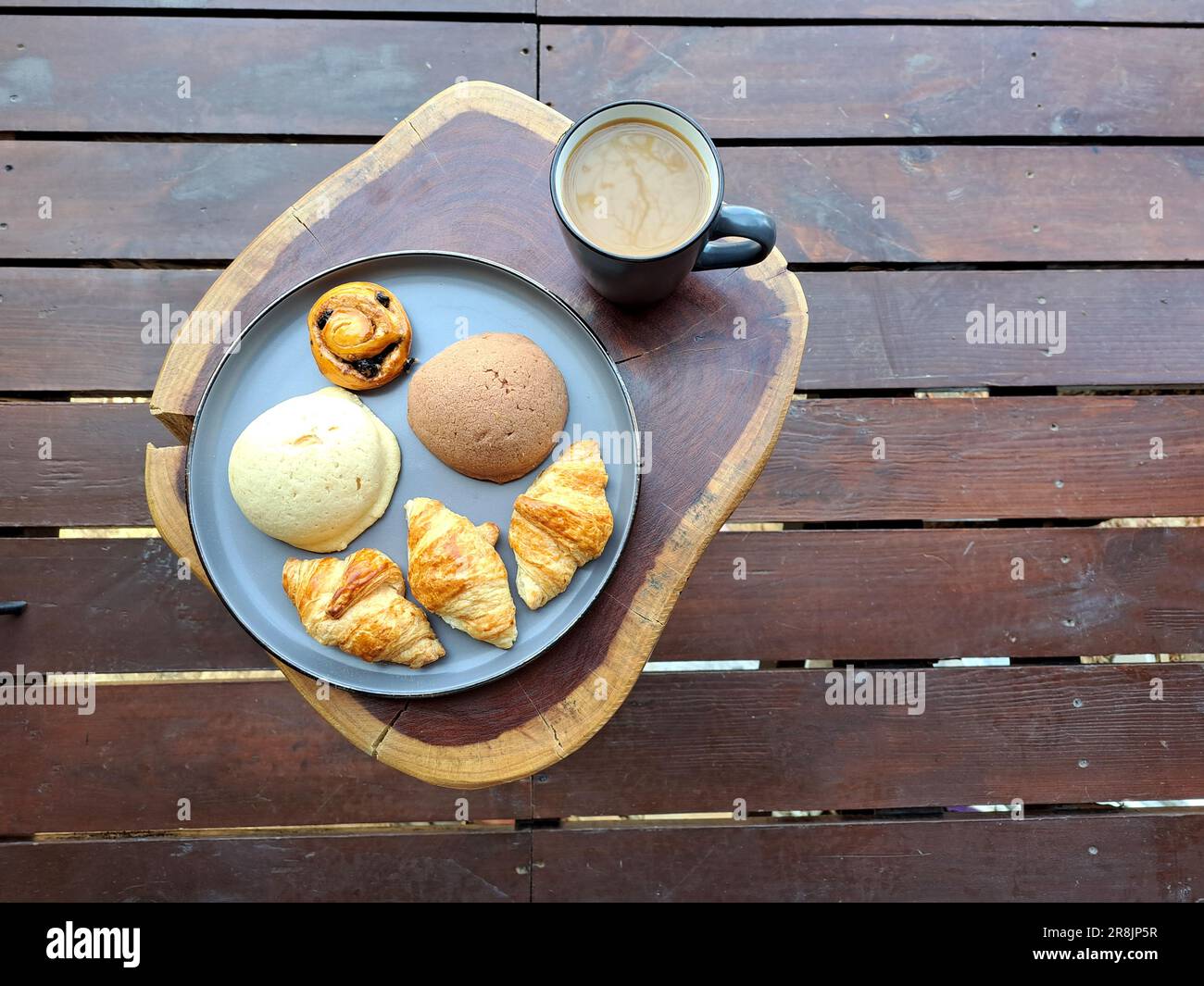 Breakfast on the terrace of a cabin in the woods on a wooden table with ...
