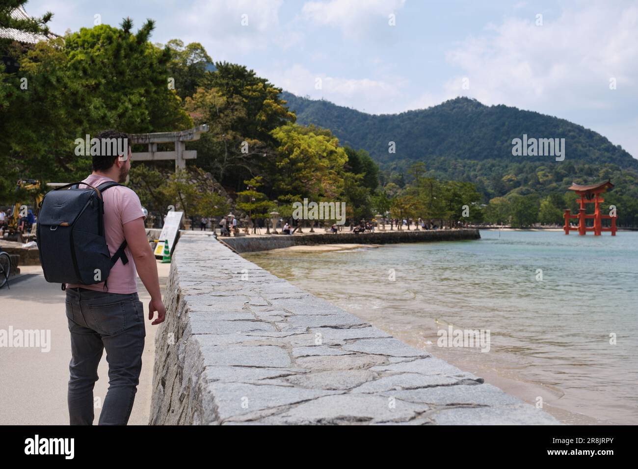 European tourist visiting Itsukushima Jinja Otorii or Grand Torii Gate ...