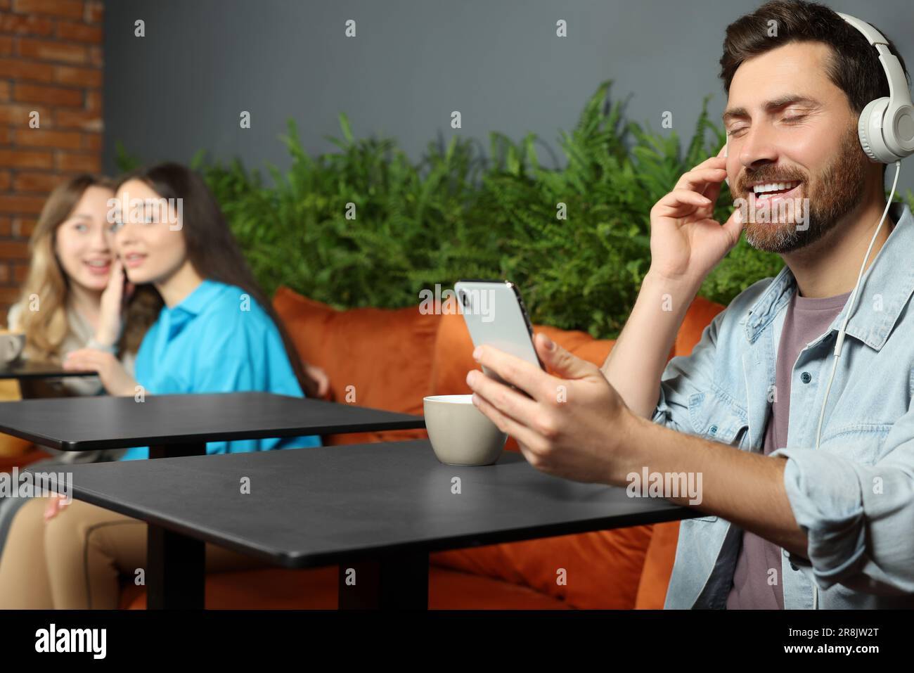 People with coffee spending time in cafe Stock Photo - Alamy