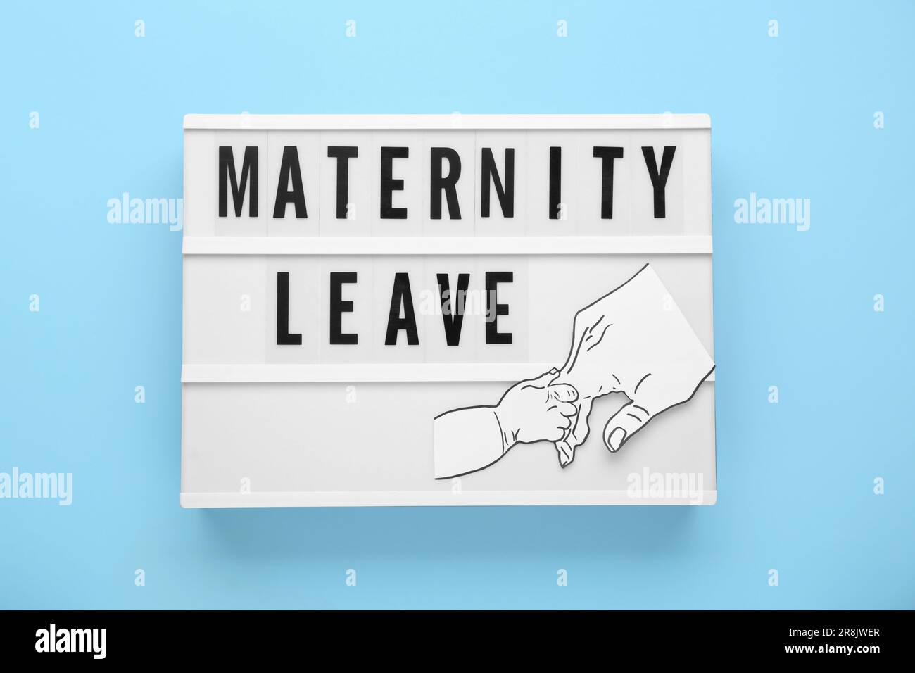 Lightbox with words Maternity Leave and paper cutout of hands on light ...