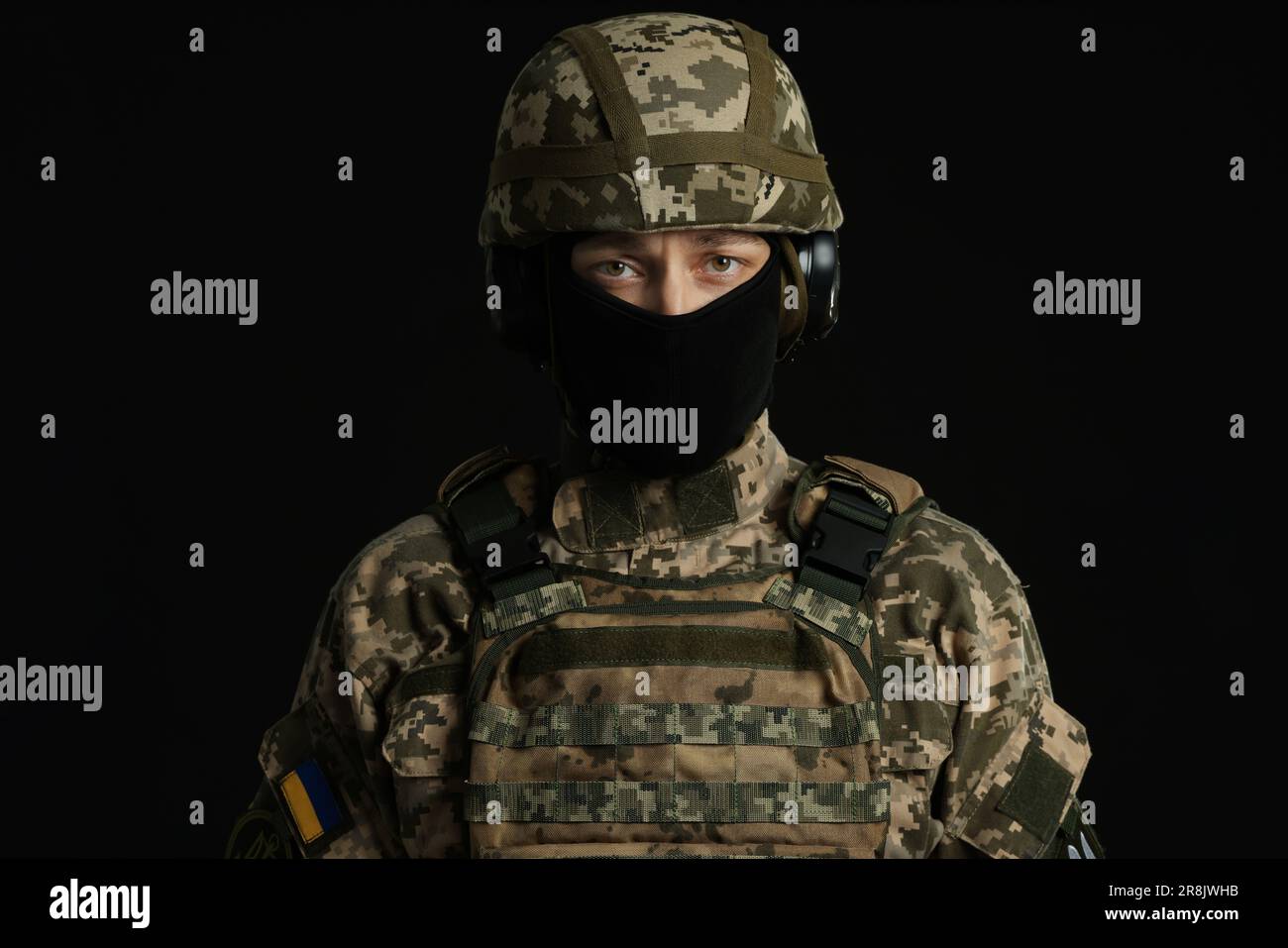 Soldier in Ukrainian military uniform on black background Stock Photo ...