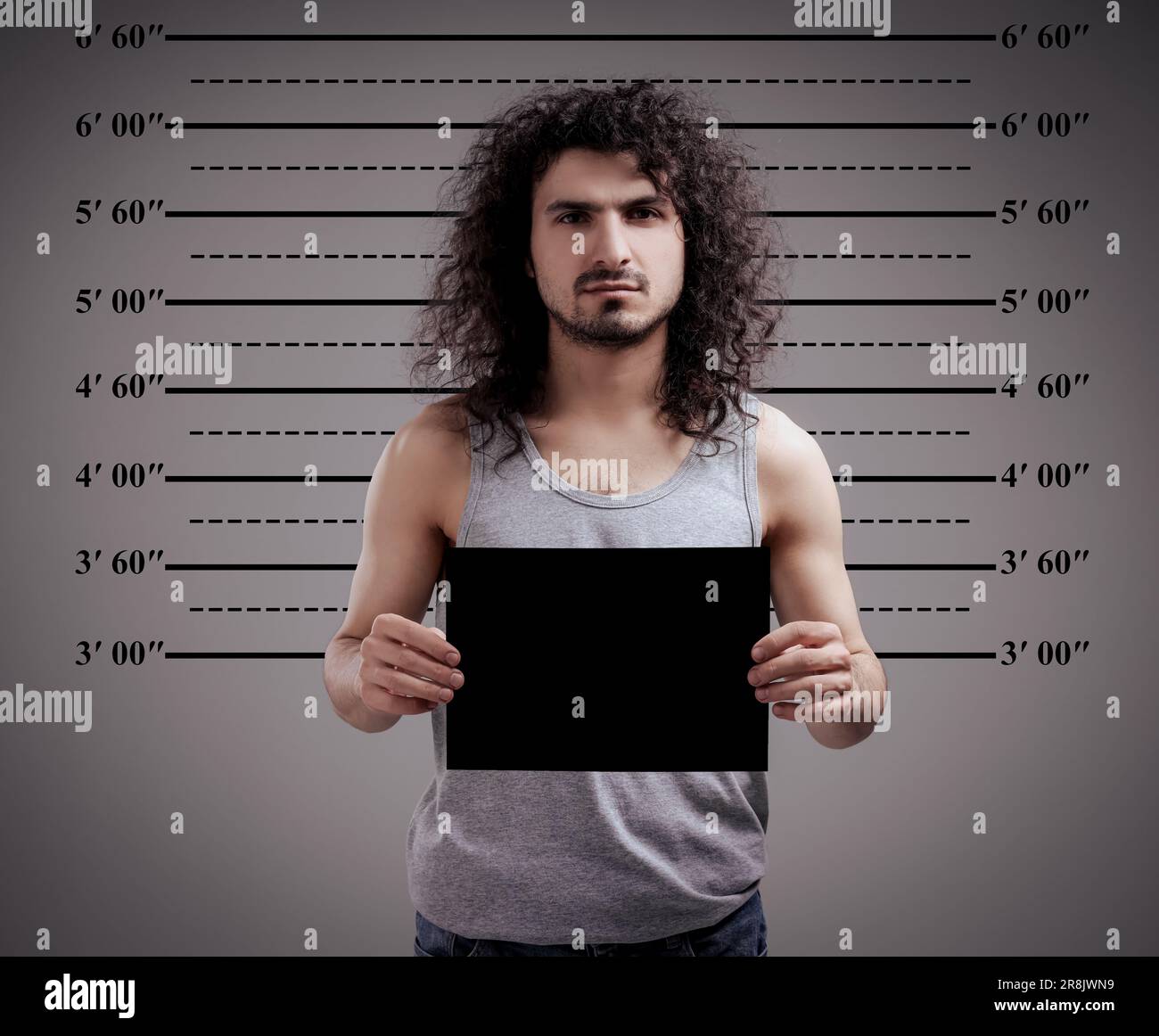 Criminal mugshot. Arrested man with blank card against height chart ...