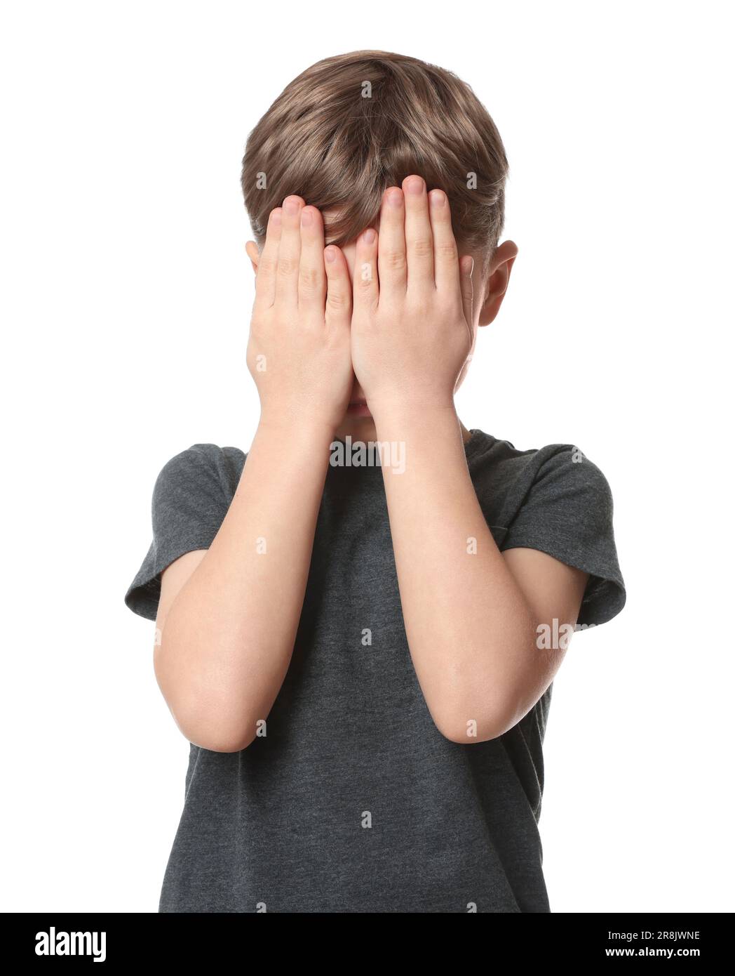 Boy covering face with hands on white background. Children's bullying ...
