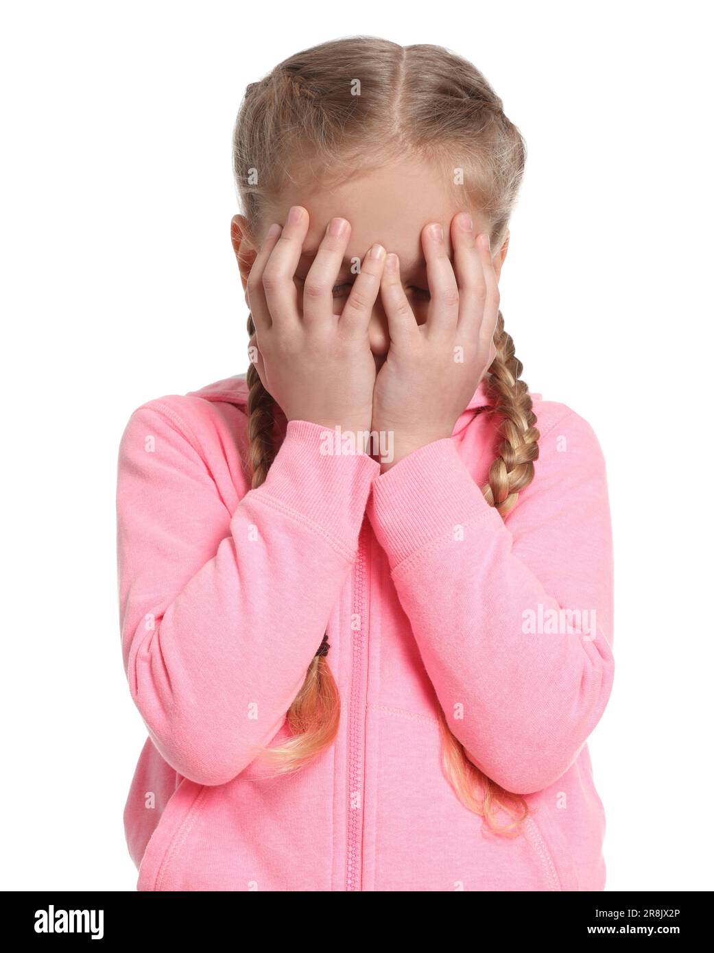 Girl covering face with hands on white background. Children's bullying ...