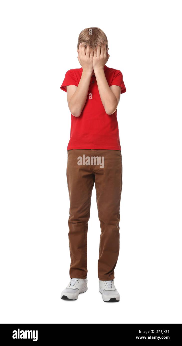 Boy covering face with hands on white background. Children's bullying ...