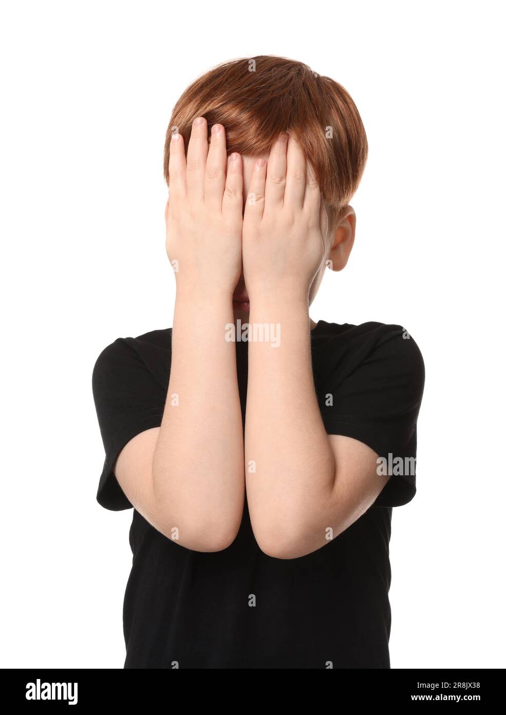 Boy covering face with hands on white background. Children's bullying ...