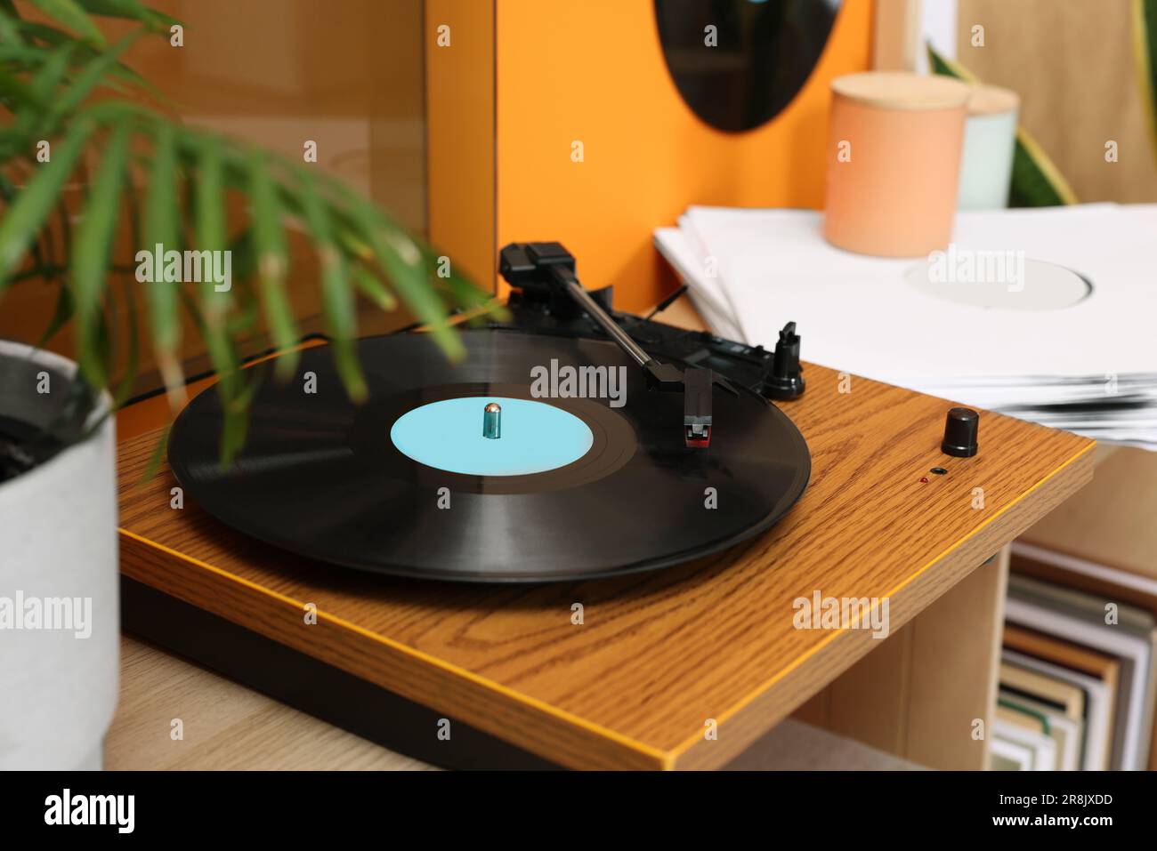 Stylish turntable with vinyl record on console table indoors Stock ...