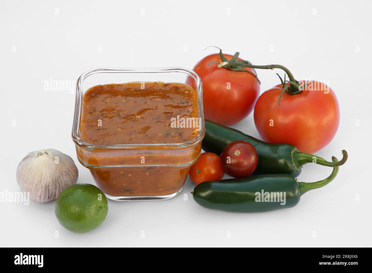 Delicious salsa sauce and ingredients on white background Stock Photo ...