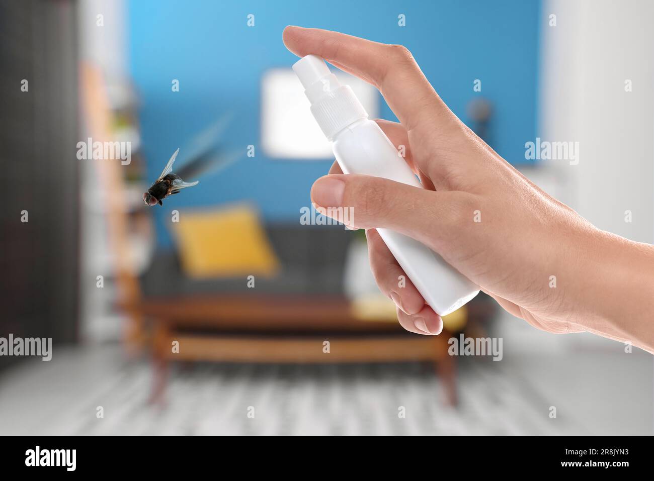 Woman using fly spray hi-res stock photography and images - Alamy