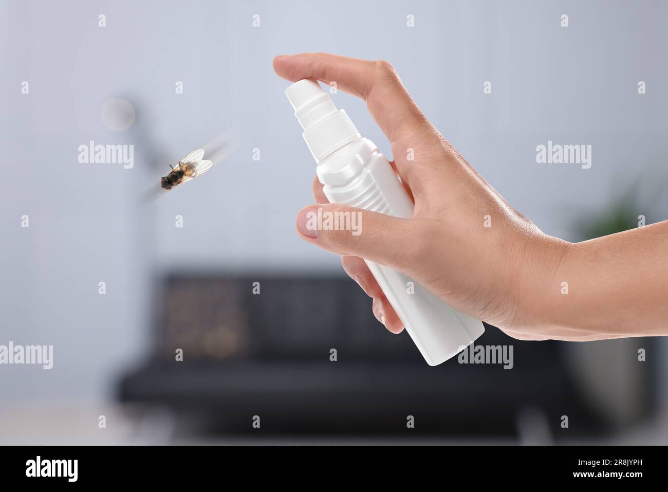 Woman using fly spray hi-res stock photography and images - Alamy