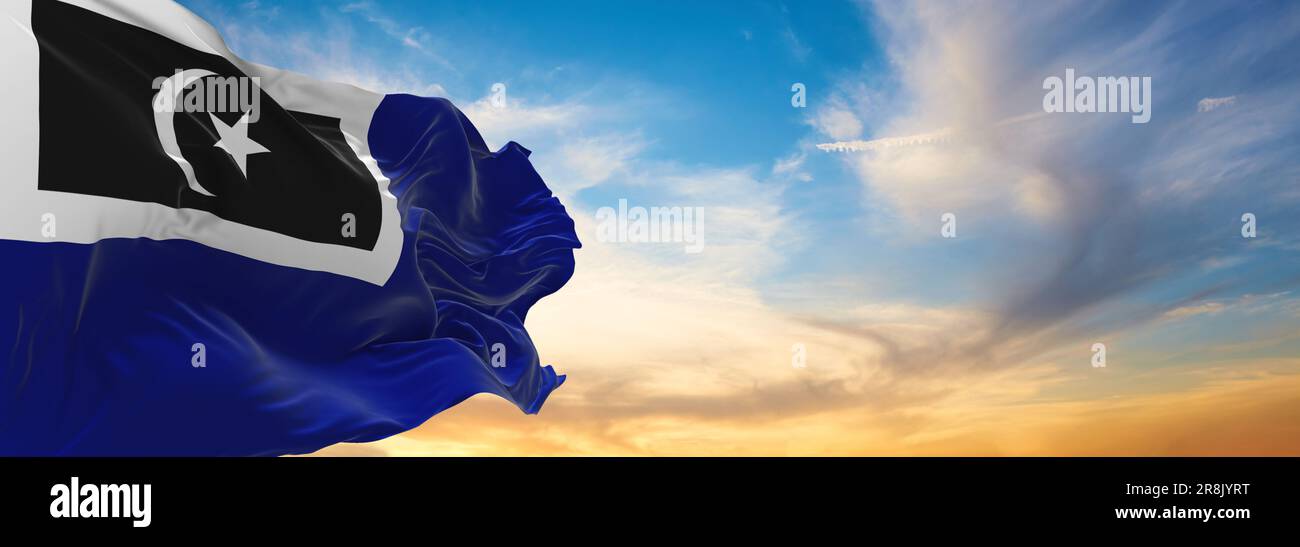 official flag of Kemaman, Terengganu Malaysia at cloudy sky background ...