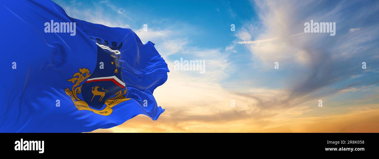 official flag of Kuching Malaysia at cloudy sky background on sunset ...