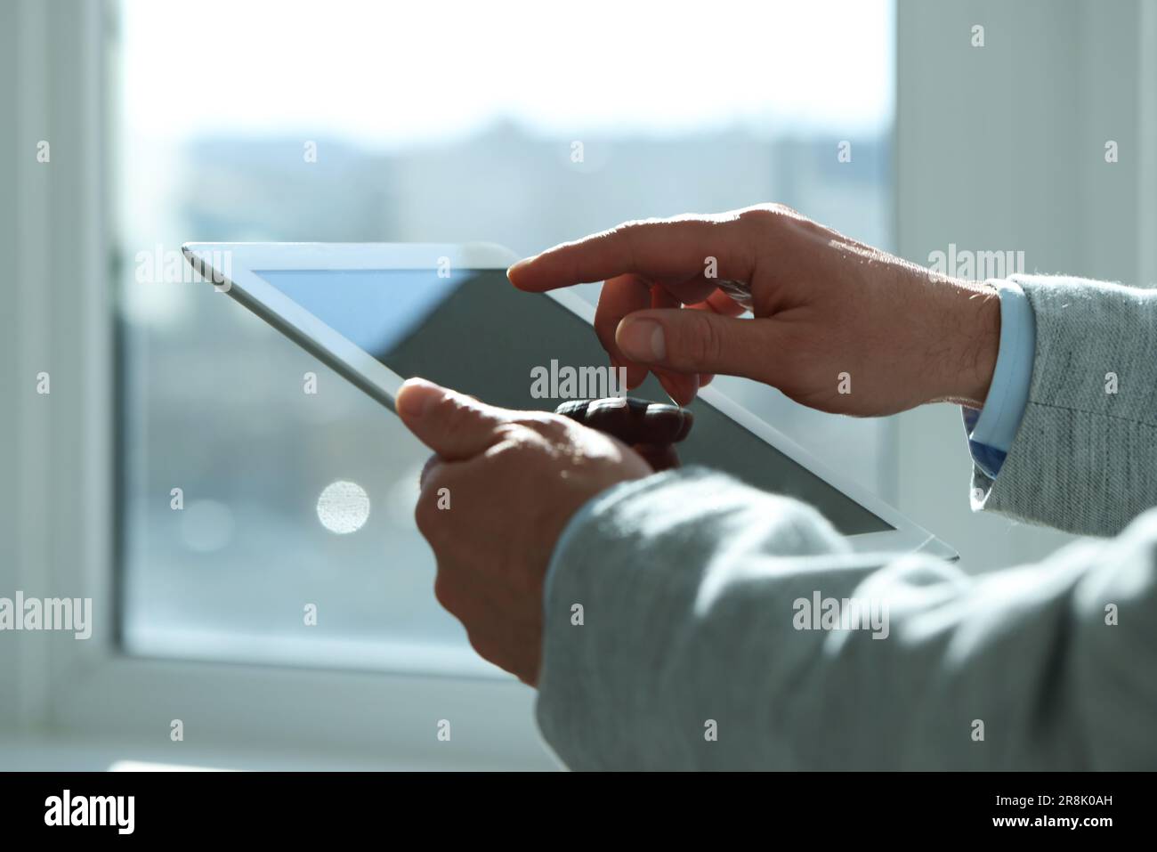 Closeup view of man using new tablet indoors Stock Photo - Alamy
