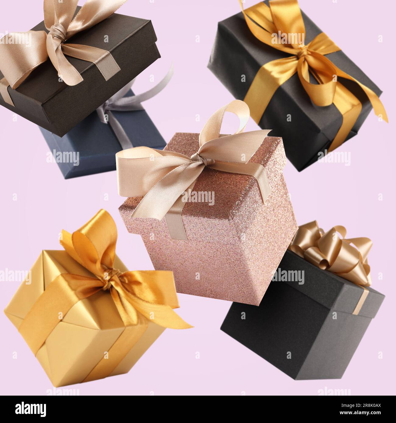 Many beautiful gift boxes falling on pastel pink background Stock Photo ...