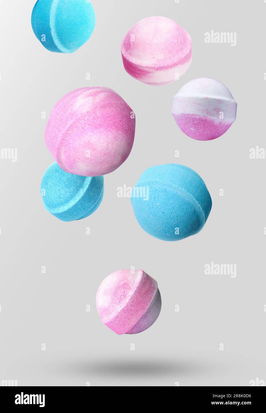 Many different bath bombs falling on light grey background Stock Photo ...