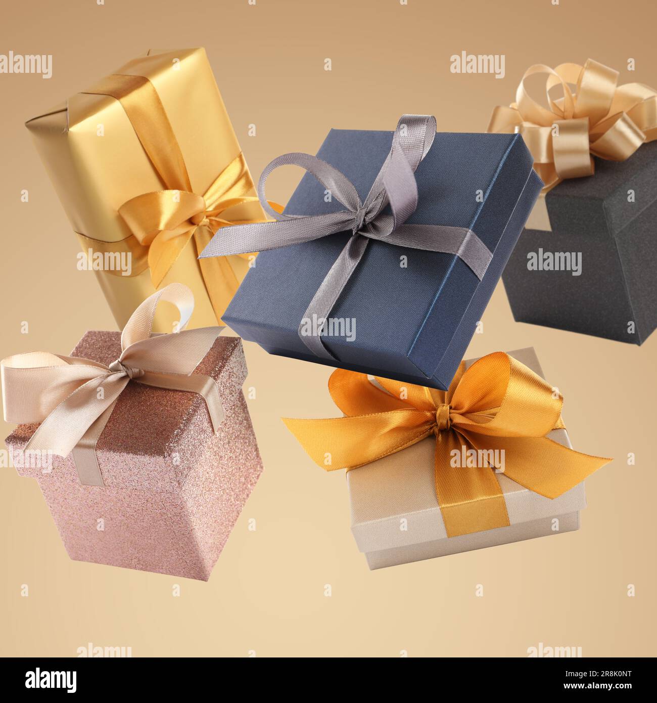 Many beautiful gift boxes falling on dark beige background Stock Photo ...