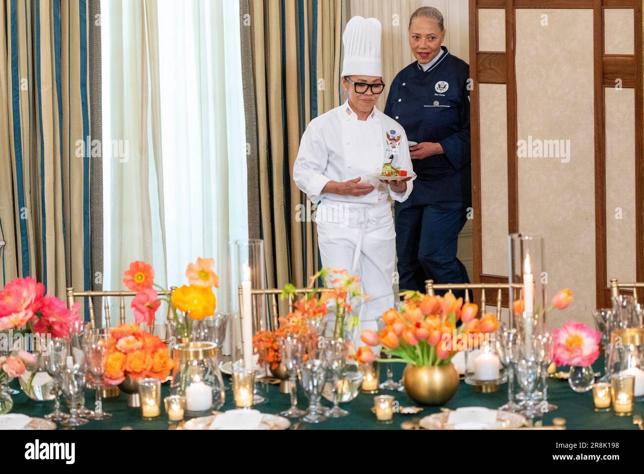 White House executive chef Cristeta Comerford, left, and guest chef ...