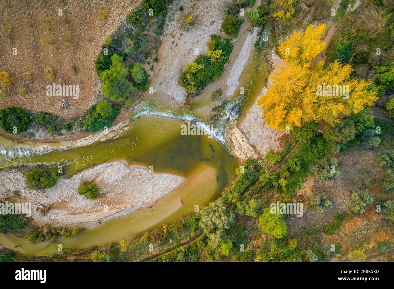 Aerial zenithal view of the Algars river as it passes through Arnes, on ...