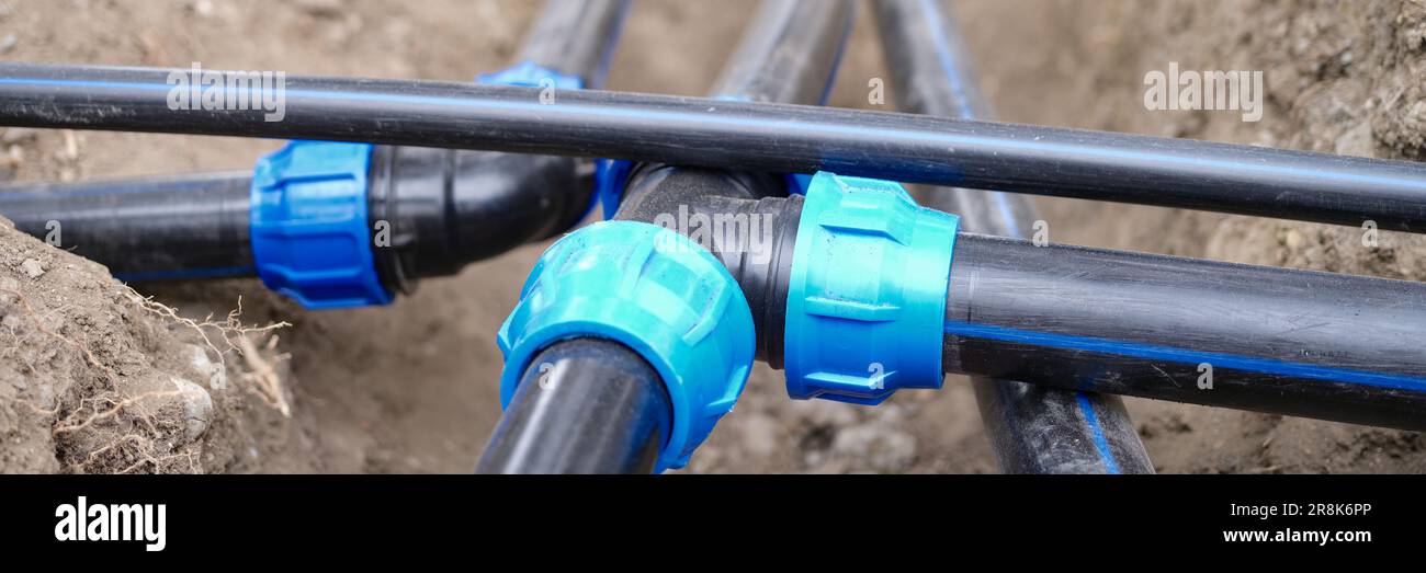 Connecting water supply plastic pipes on ground Stock Photo - Alamy