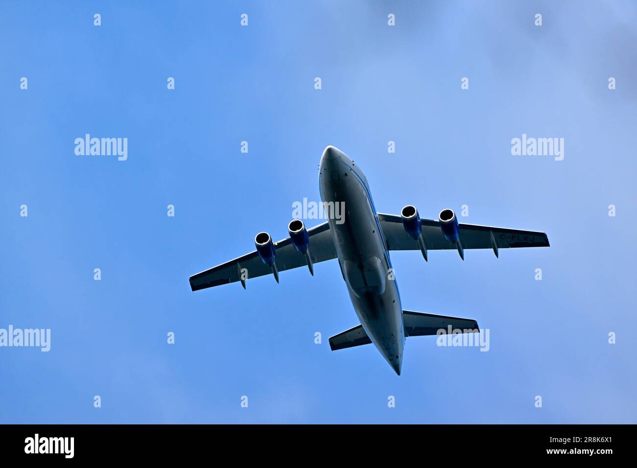 A commuter passenger plane flying in a cloud filled sky Stock Photo - Alamy
