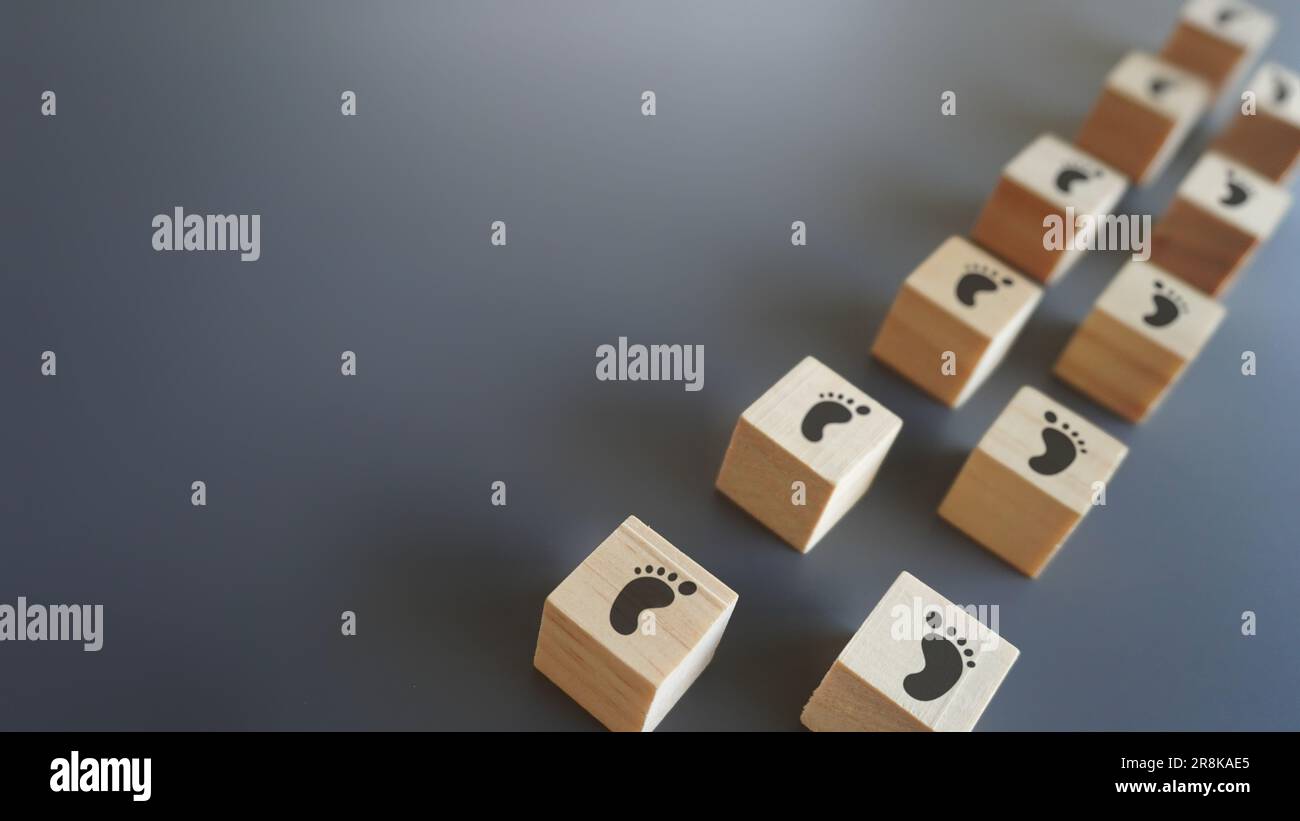 Wooden blocks with footsteps icon and copy space. Progress, step by ...