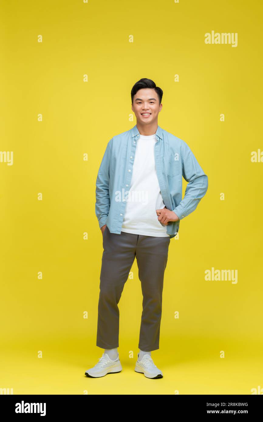 full body image of asian man posing on yellow background Stock Photo ...