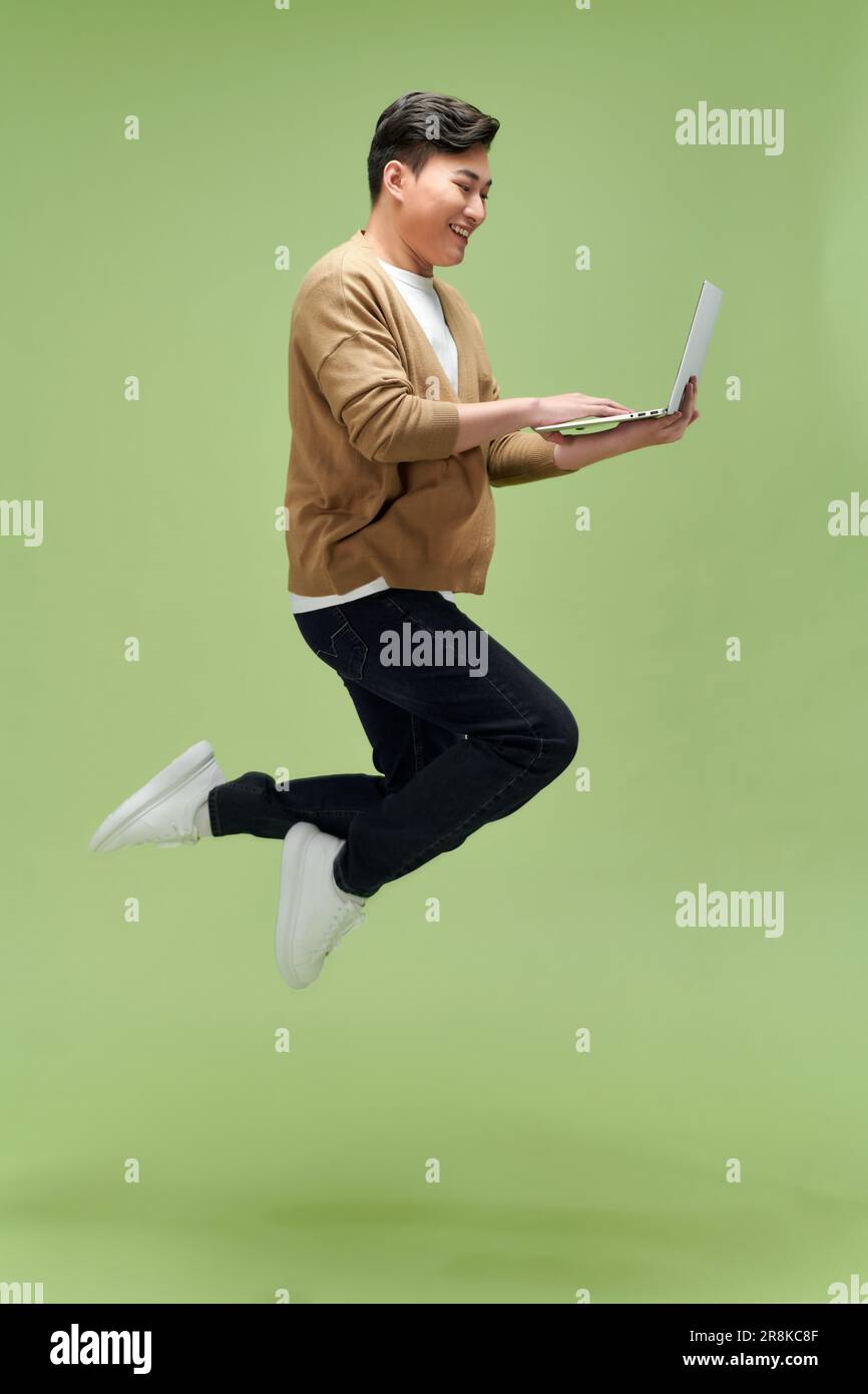 Profile photo of sporty active guy jump hold netbook run work isolated ...