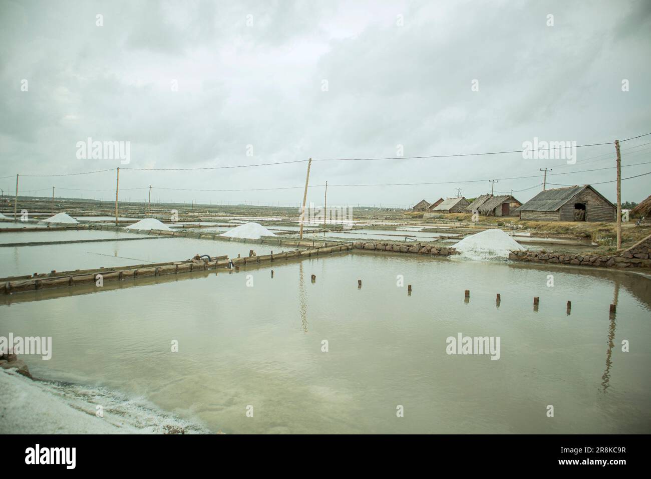 Salt farm in winter season with cloudy sky background. Salt production ...