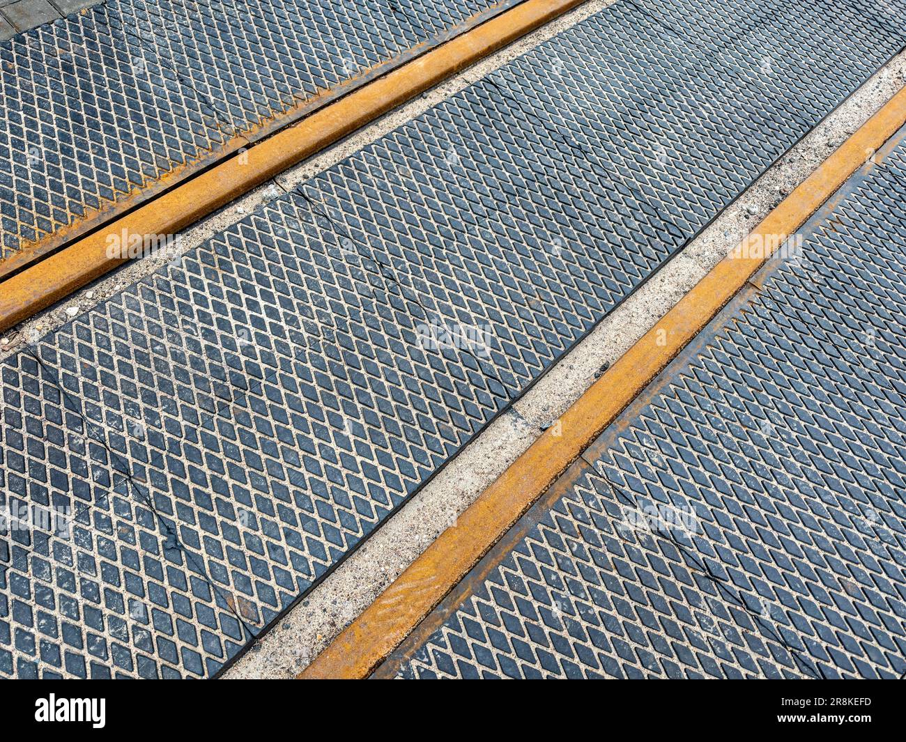 metal floor plate crosswalk through narrow-track railway. urban ...