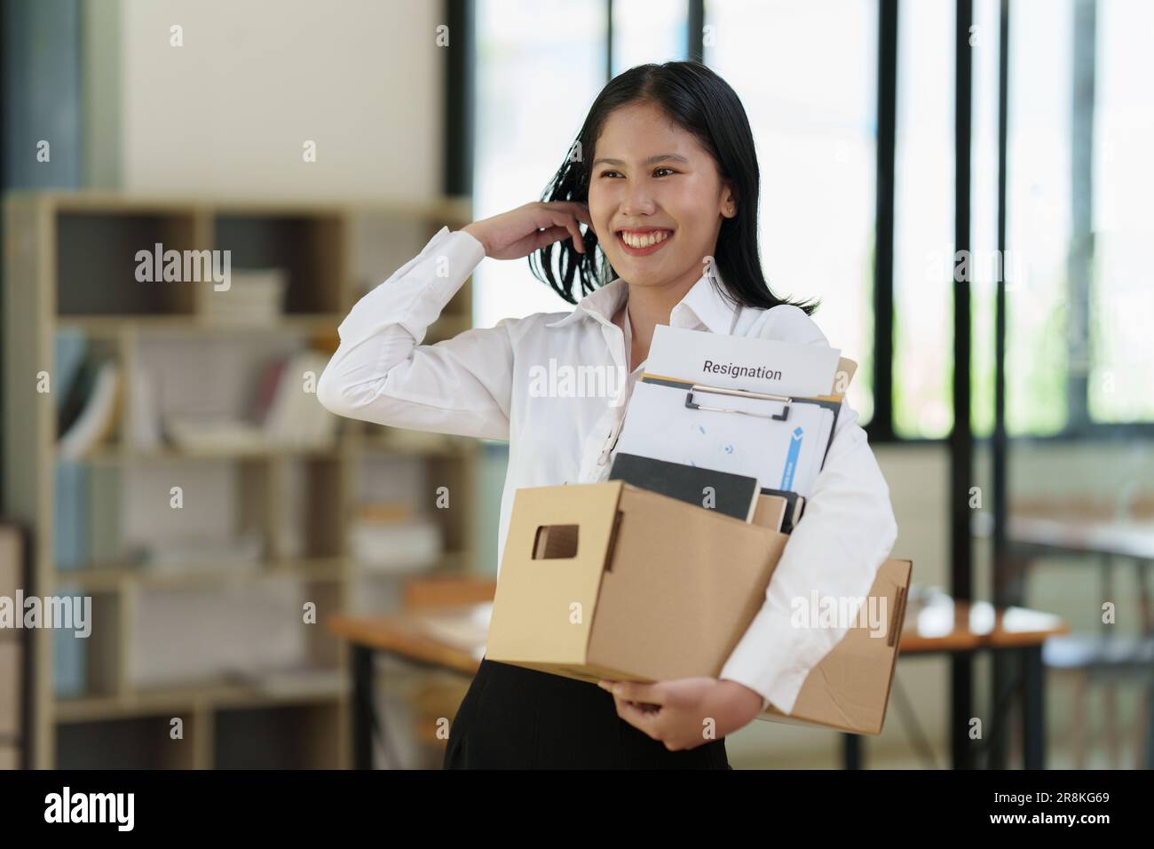Resignation concept. Employee holding box of belongings in an office ...