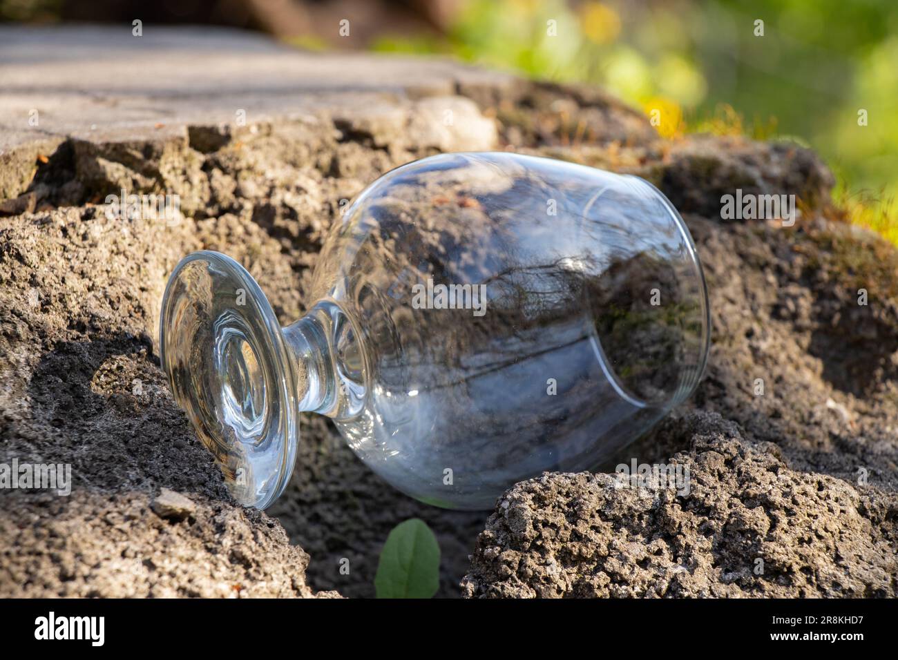 an empty transparent glass goblet stands on the ground Stock Photo - Alamy
