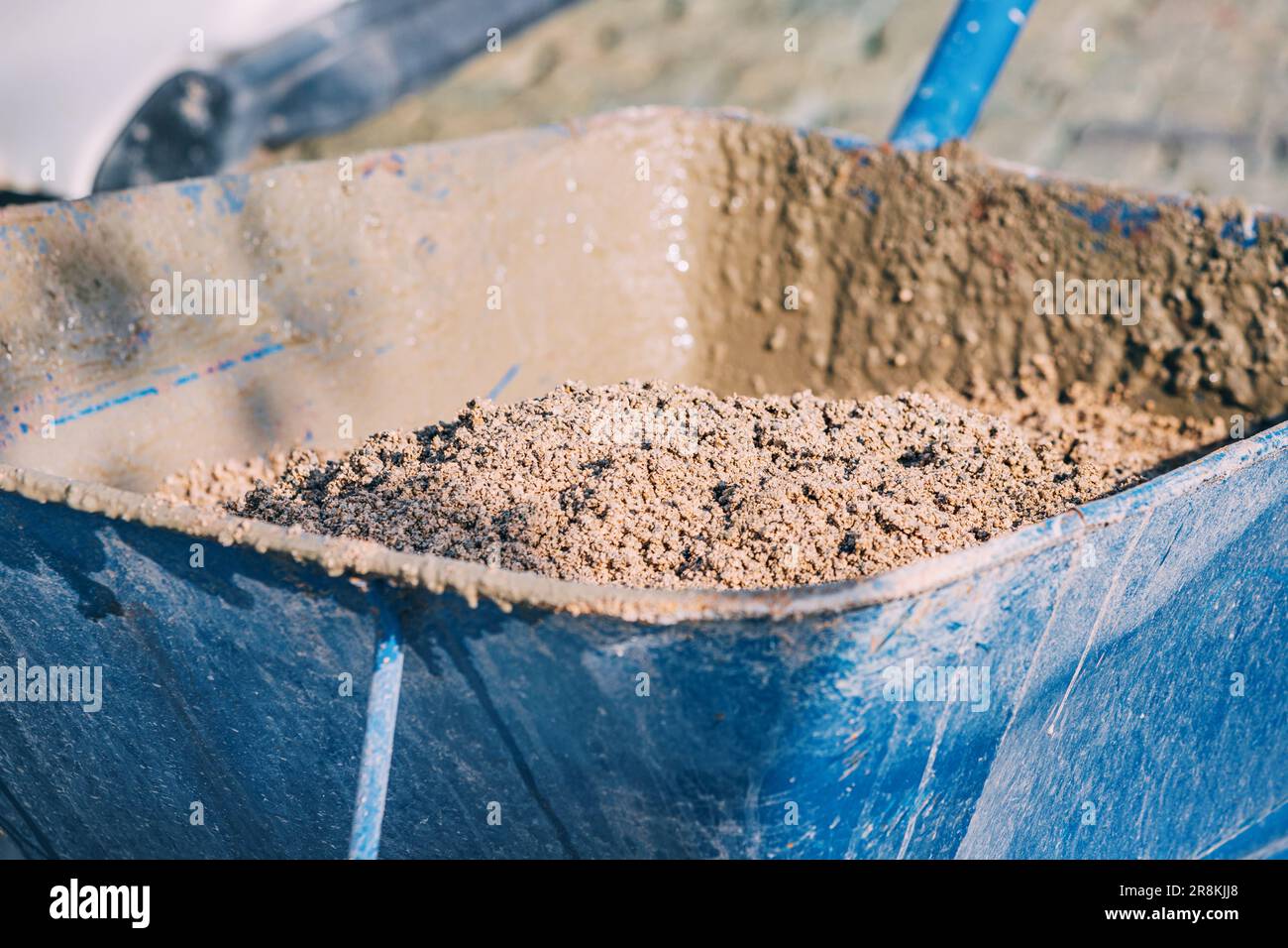 a cart with wet cement for construction. Hard manual labor and prices ...
