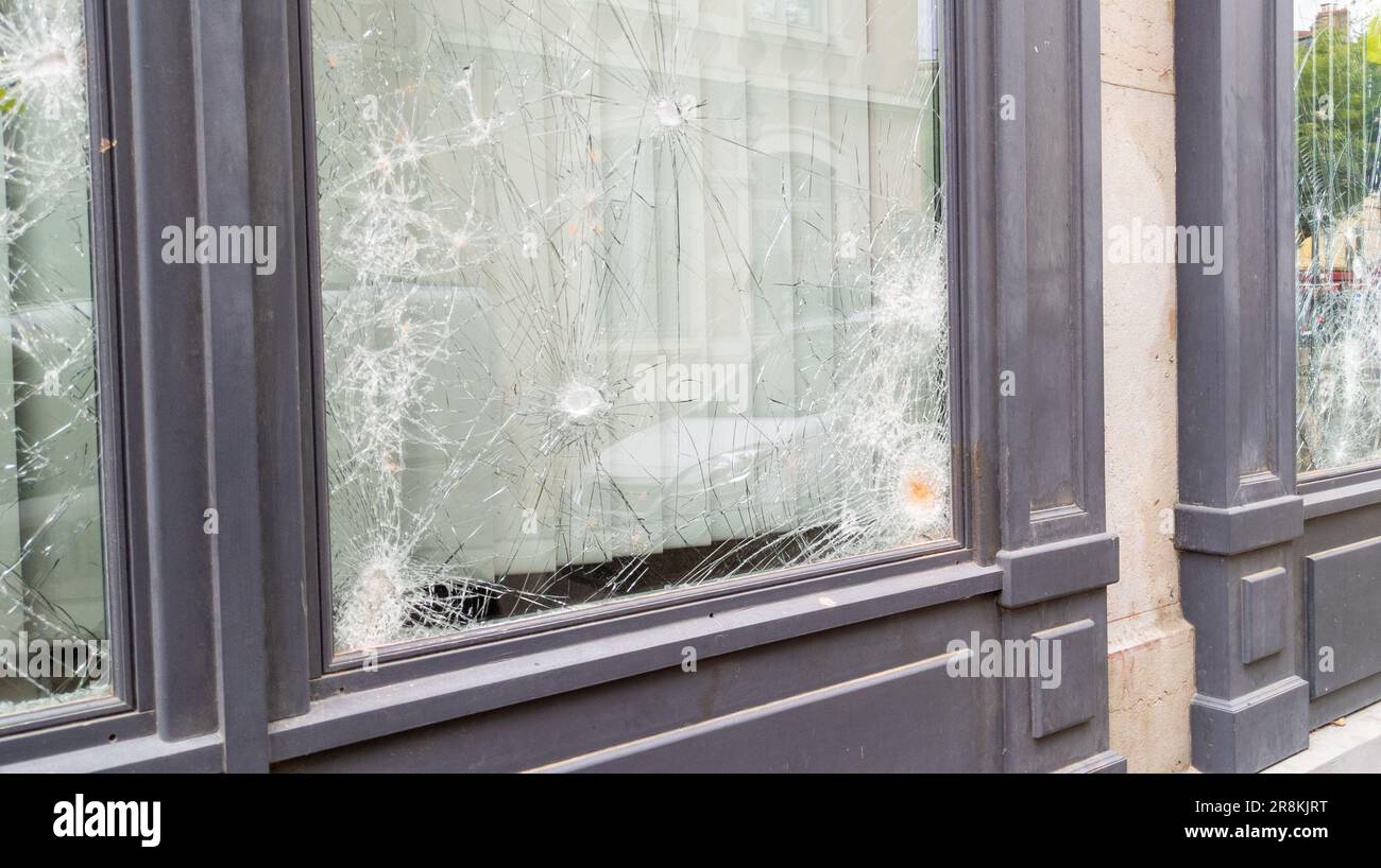 Broken shop impact of stone and hammer on facade store window Stock ...