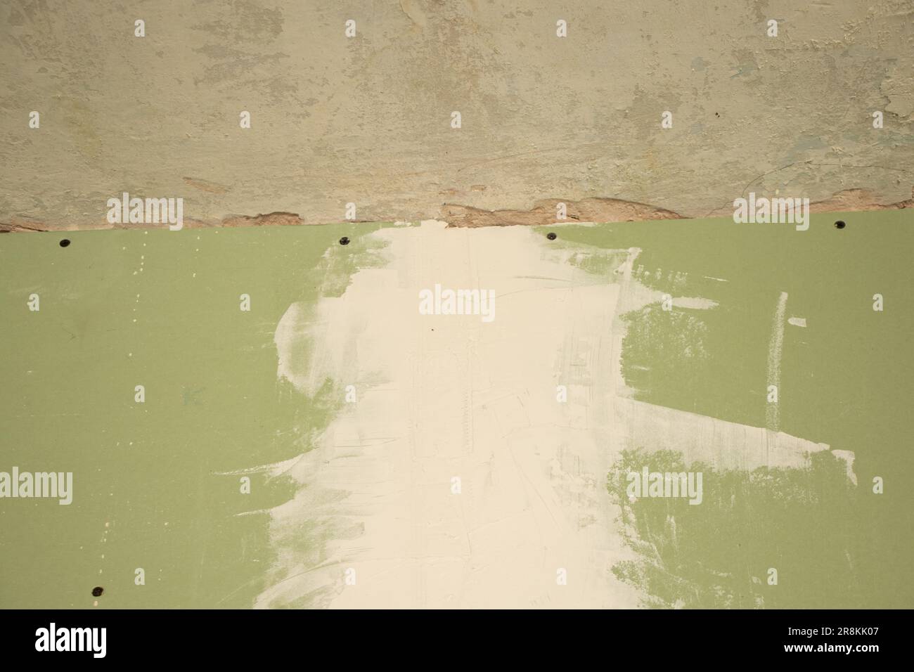 the wall is sheathed with moisture-resistant green plasterboard in the ...