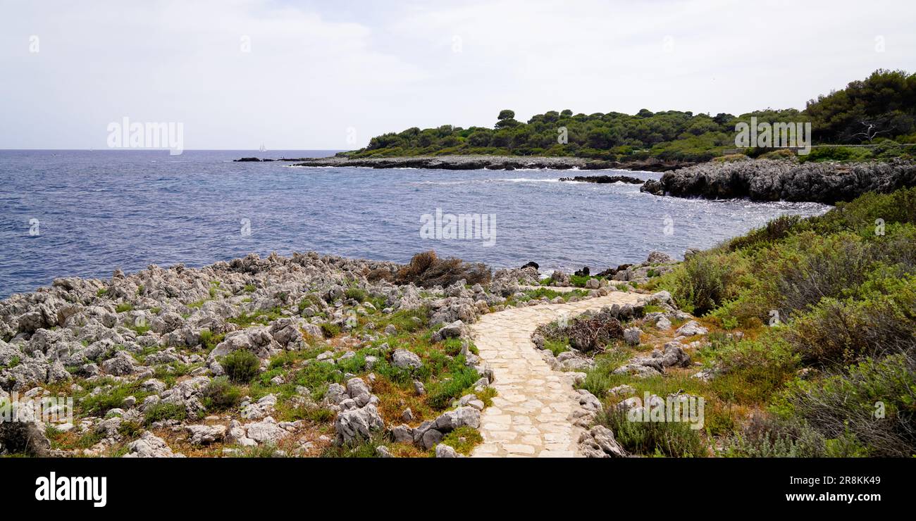 Coast pathway stone to access beach bay in Antibes Juan-les-Pins France ...