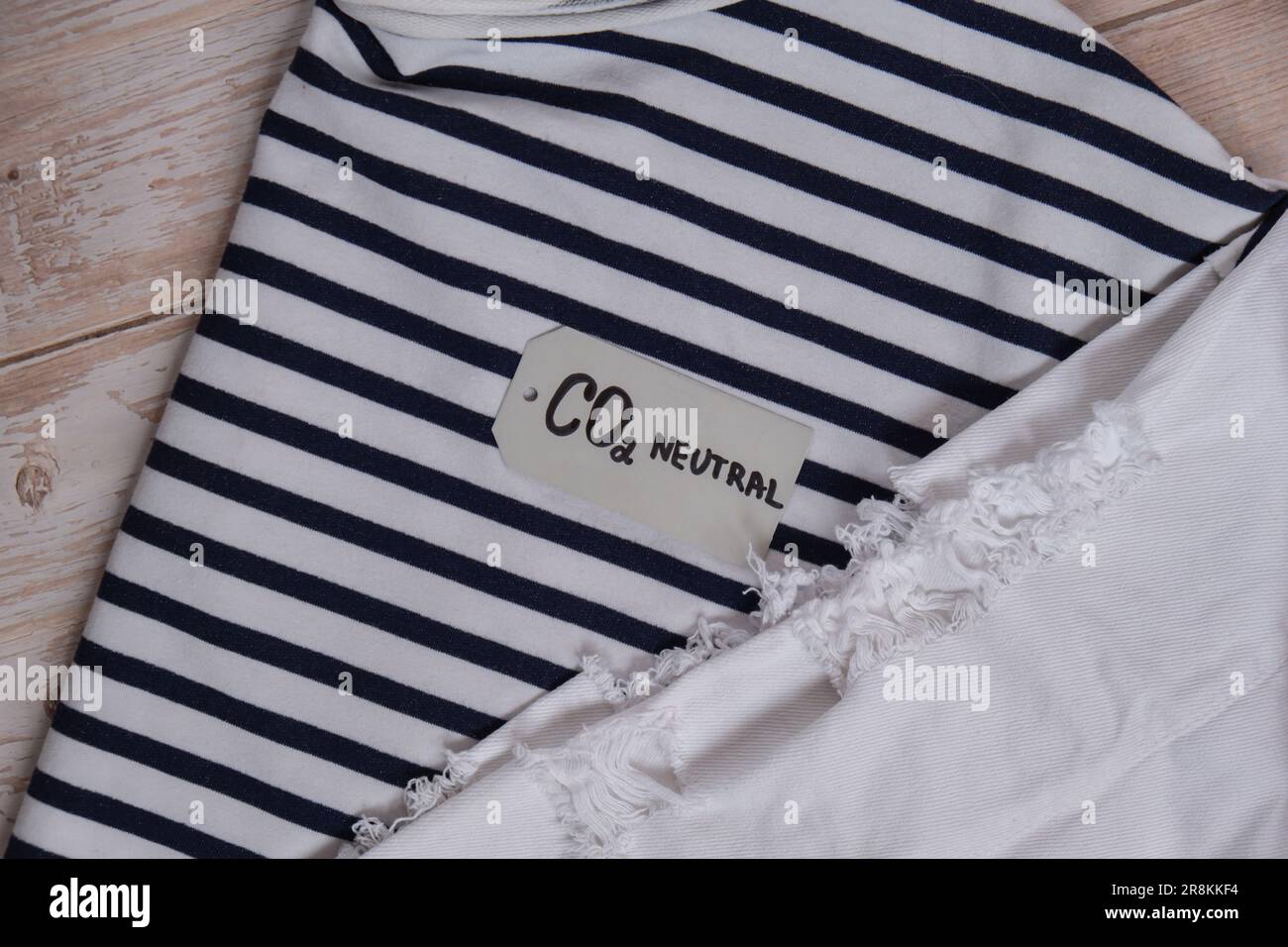 CO2 neutral emission text note on stack of clothes. Ecology nature ...