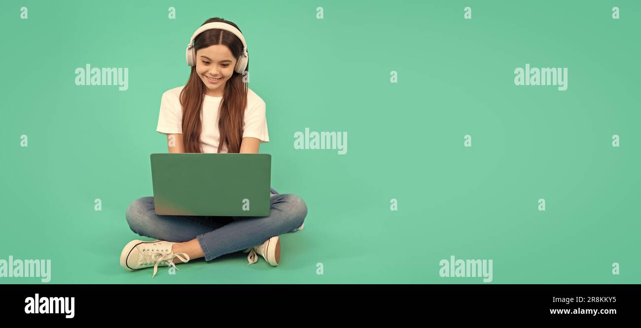 happy kid girl use wireless laptop for video call or listen webinar in ...