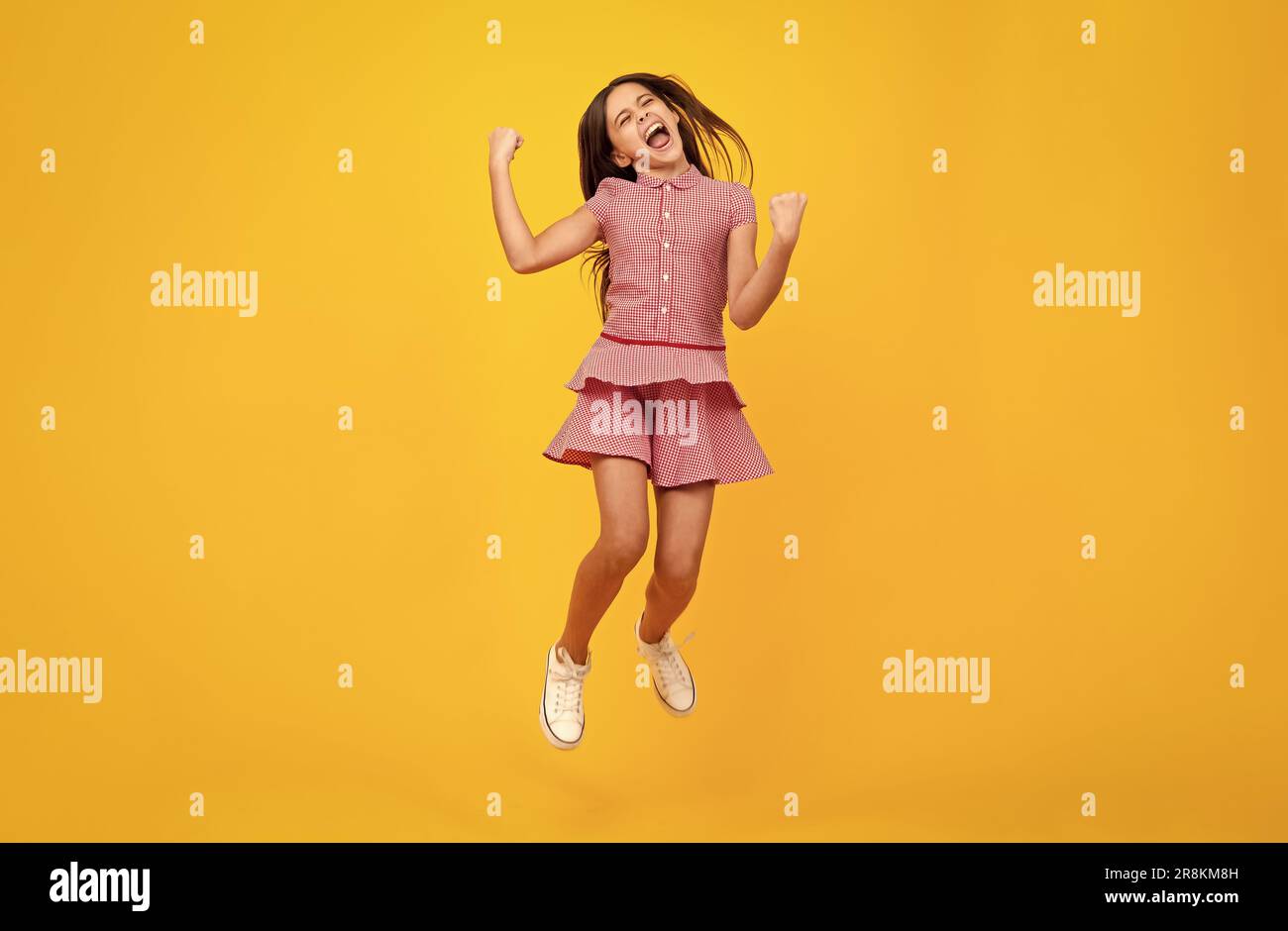 Amazed teen girl. Overjoyed teenage child jumping and gesturing ...