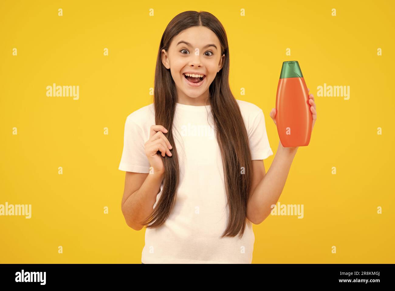 Happy portrait of child teen girl with shampoos conditioners and shower ...