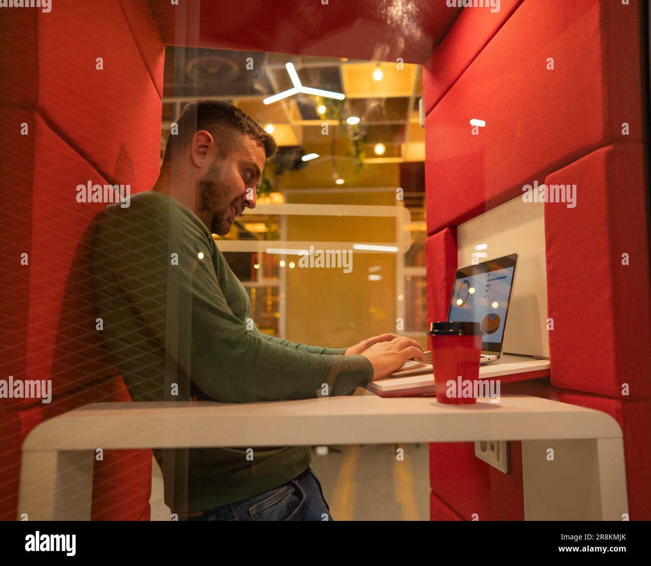 A bearded man in a booth for online negotiations. Privacy booth Stock ...