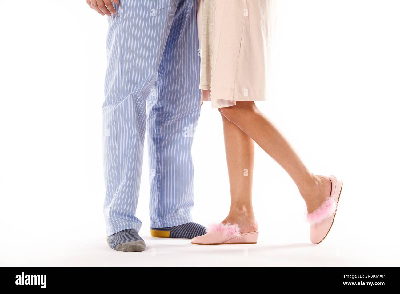 Couple in pajama. White background. Legs detail. Night wear Stock Photo ...