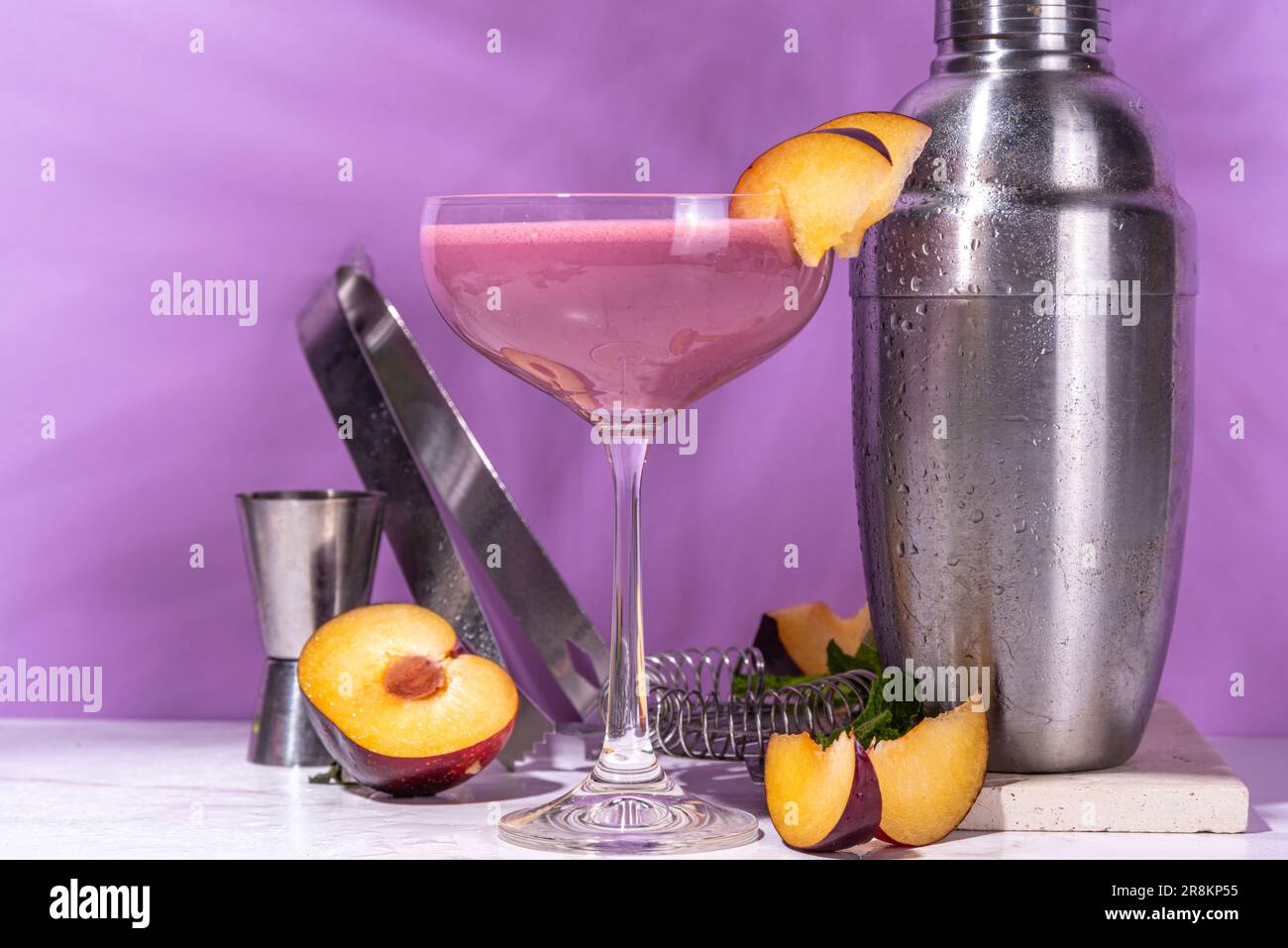 Sweet summer cold plum daiquiri or martini cocktail, liquor with red ...