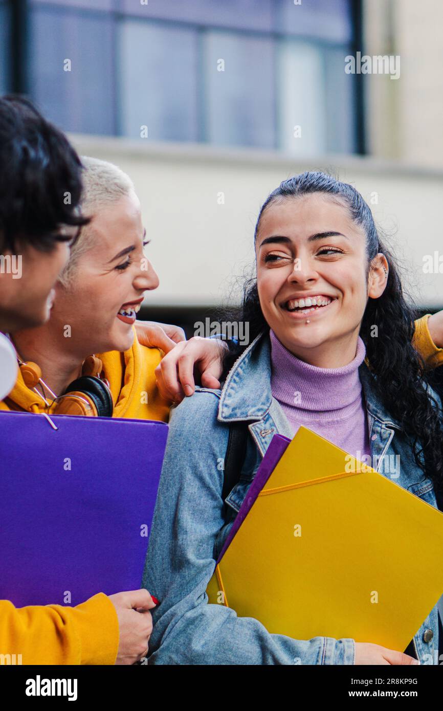 Vertical portrait of a group of schoolgirls smiling and having fun at ...