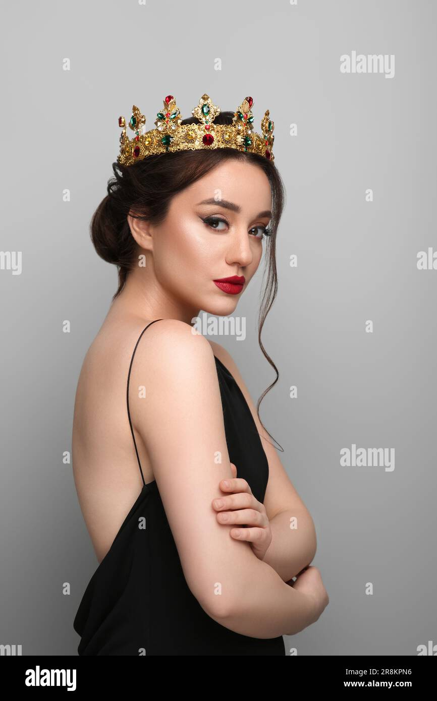 Beautiful young woman wearing luxurious crown on light grey background Stock Photo - Alamy